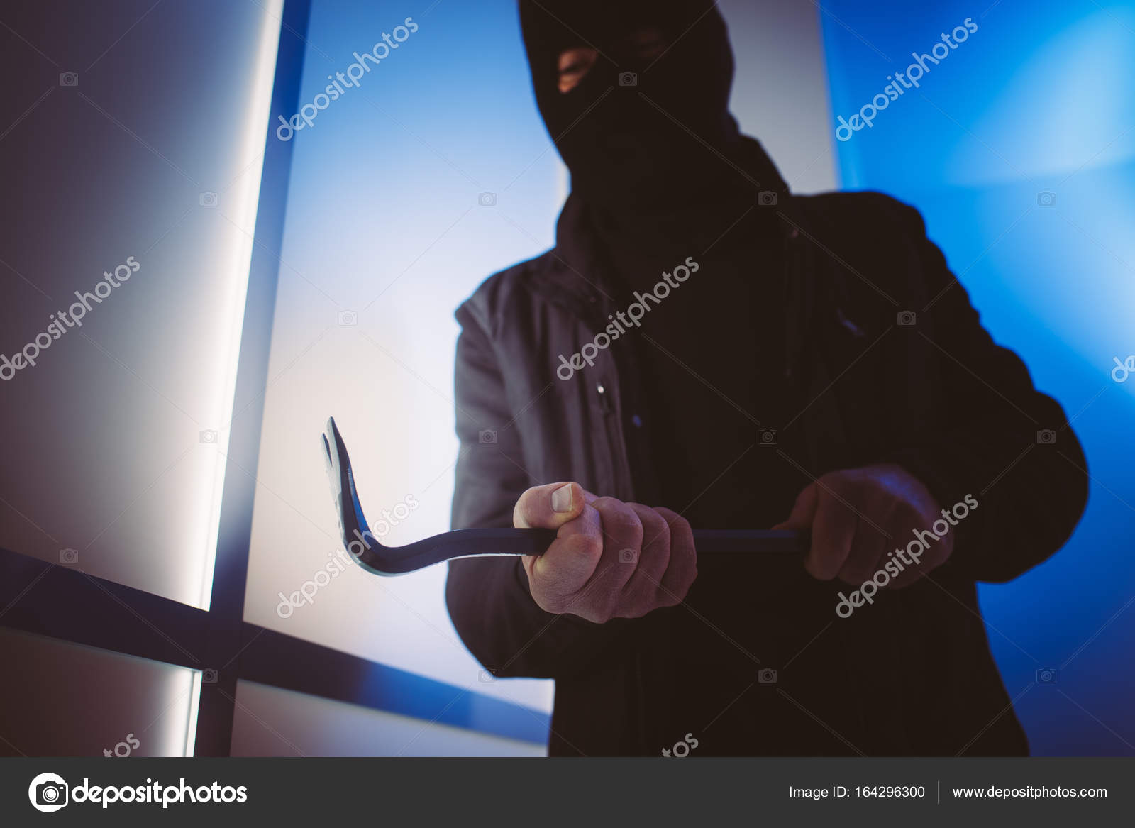 Burglar using crowbar to break into house Stock Photo by ©stokkete ...