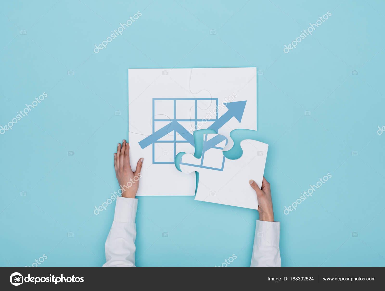 Woman completing puzzle with graph icon Stock Photo by ©stokkete 188392524
