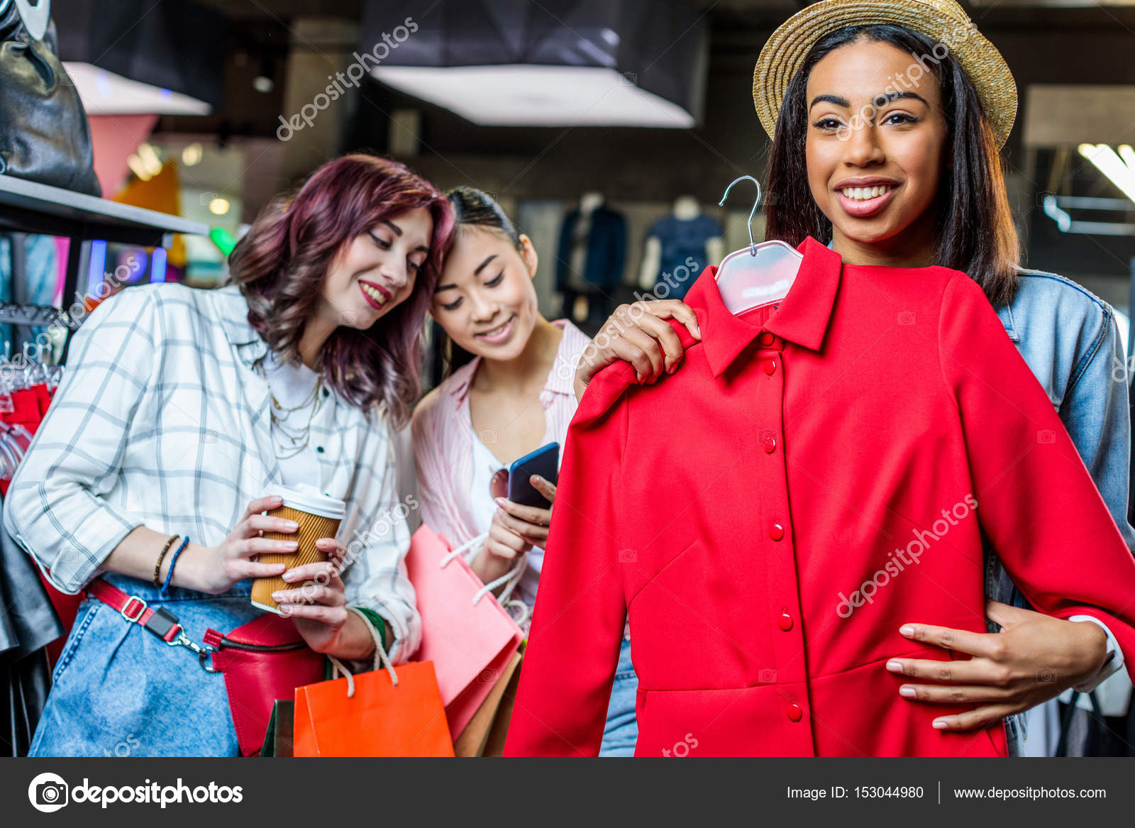 Multicultural girls in boutique Stock Photo by ©AndrewDemenyuk 153044980