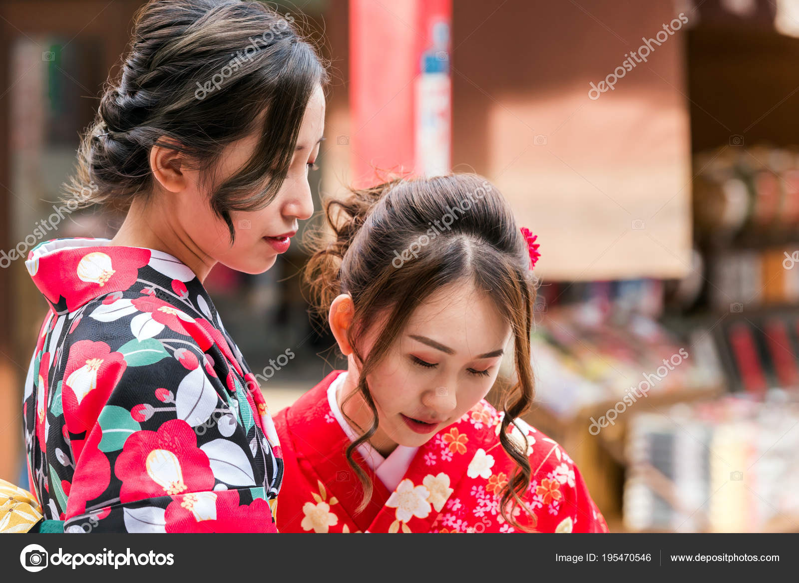 TOKYO, JAPAN - OCTOBER 31, 2017: Two girls in a kimono on a city street ...