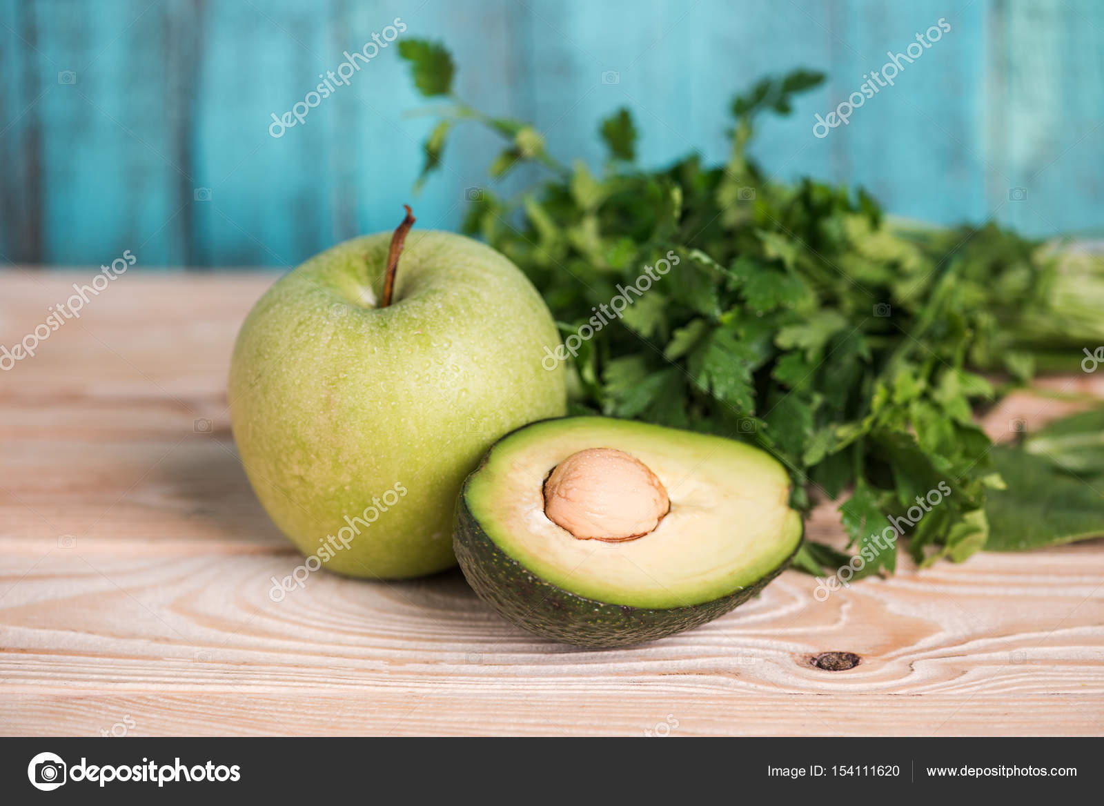 Ripe avocado with parsley and apple on wooden table — Stock Photo ...