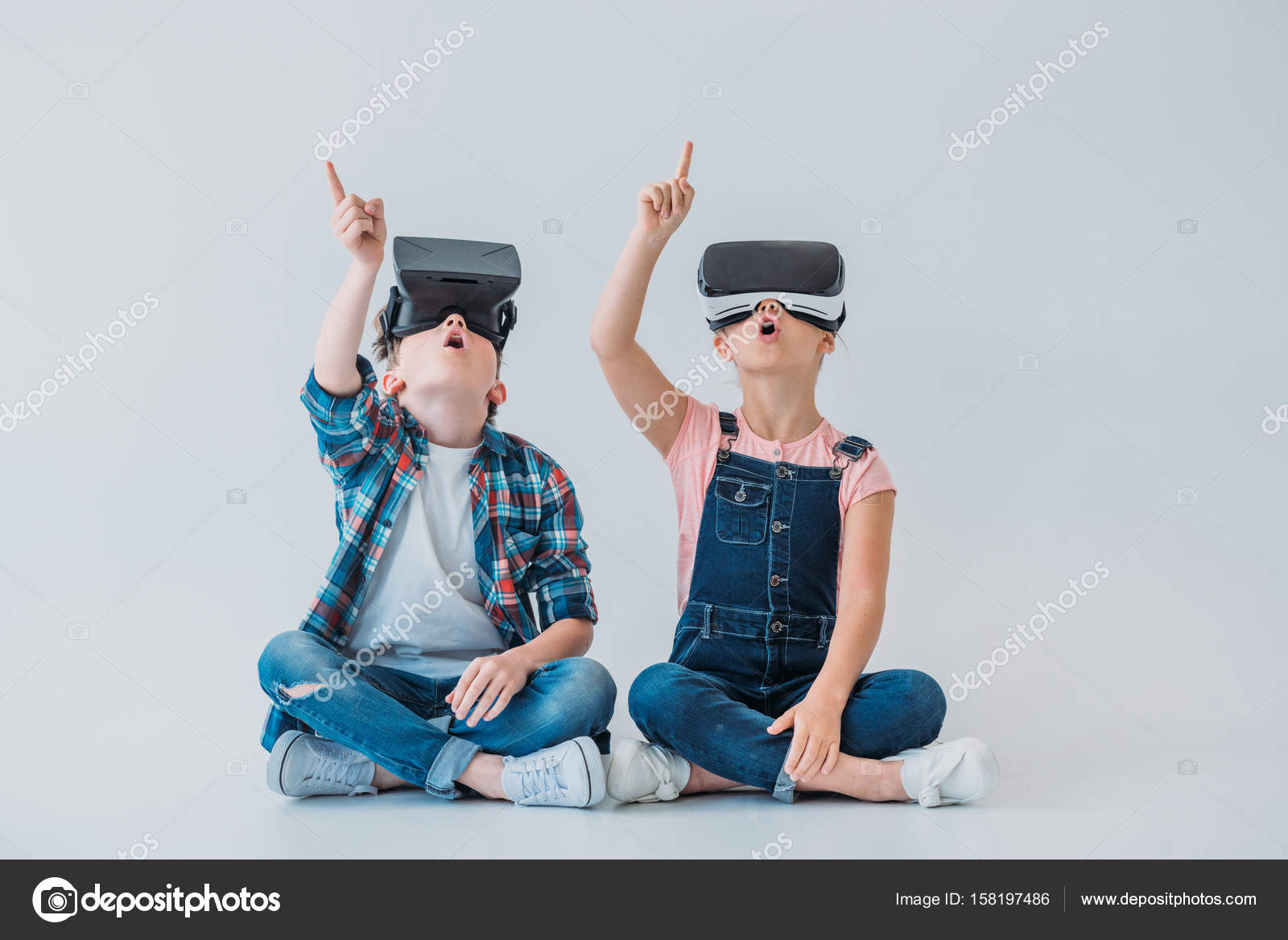 Kids using virtual reality headsets Stock Photo by ©alebloshka 158197486