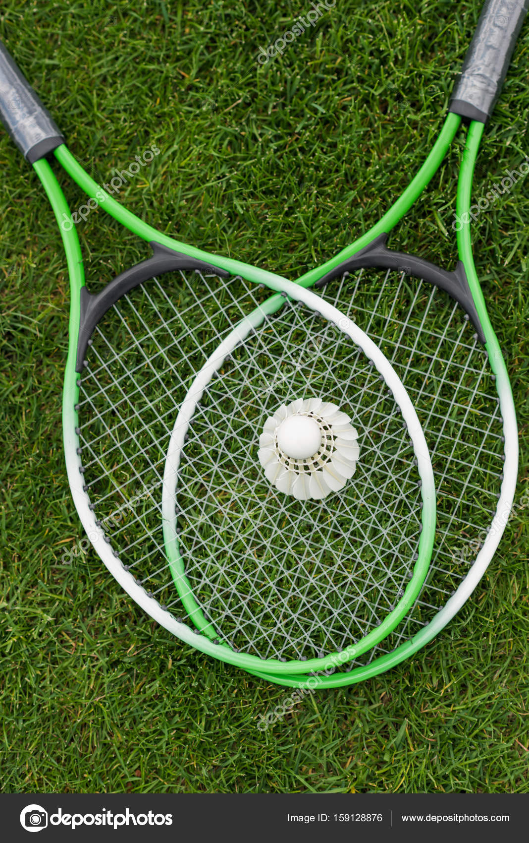 Shuttlecock on badminton rackets — Free Stock Photo © alebloshka #159128876