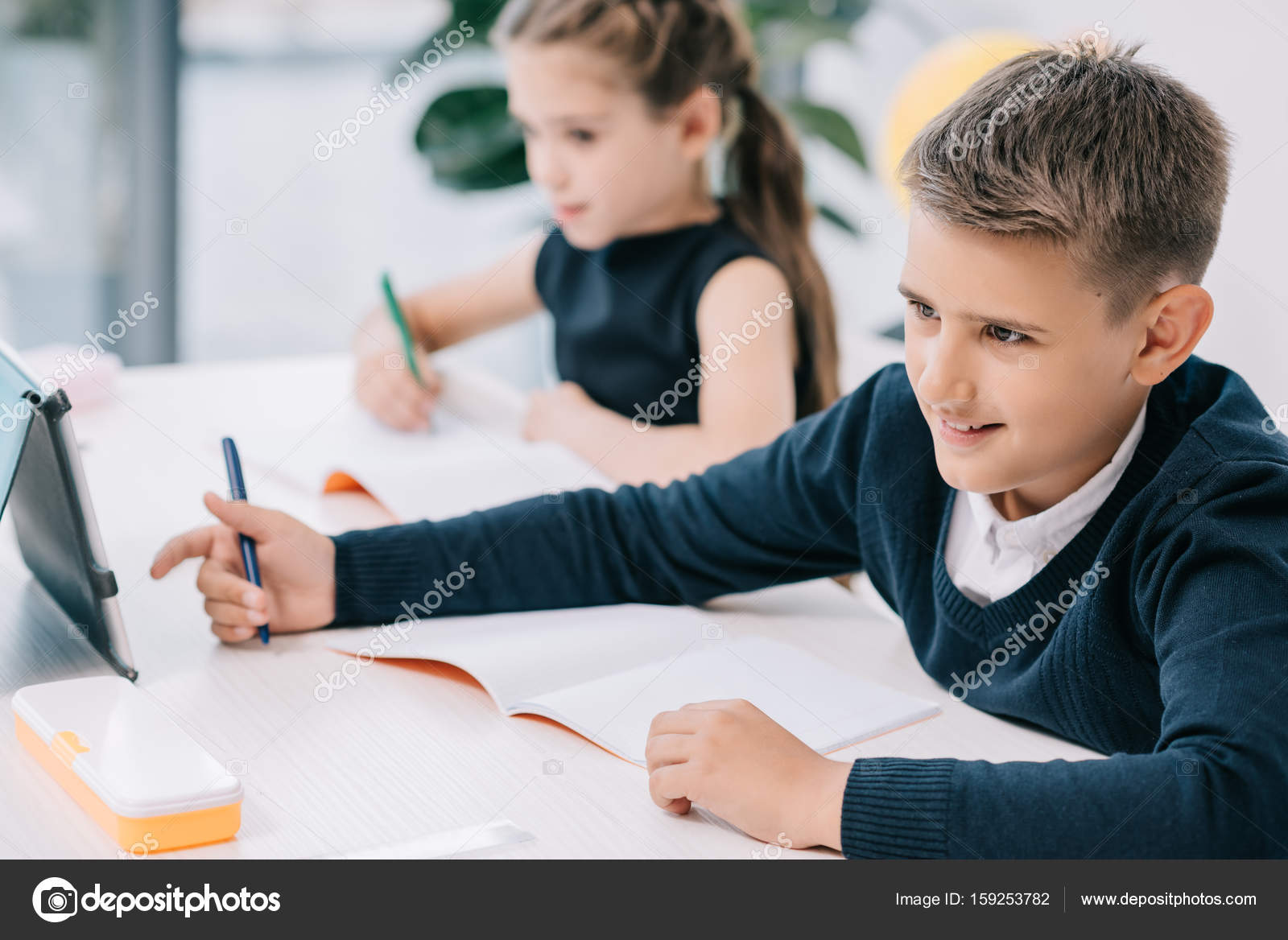 Schoolkids studying in classroom Stock Photo by ©alebloshka 159253782