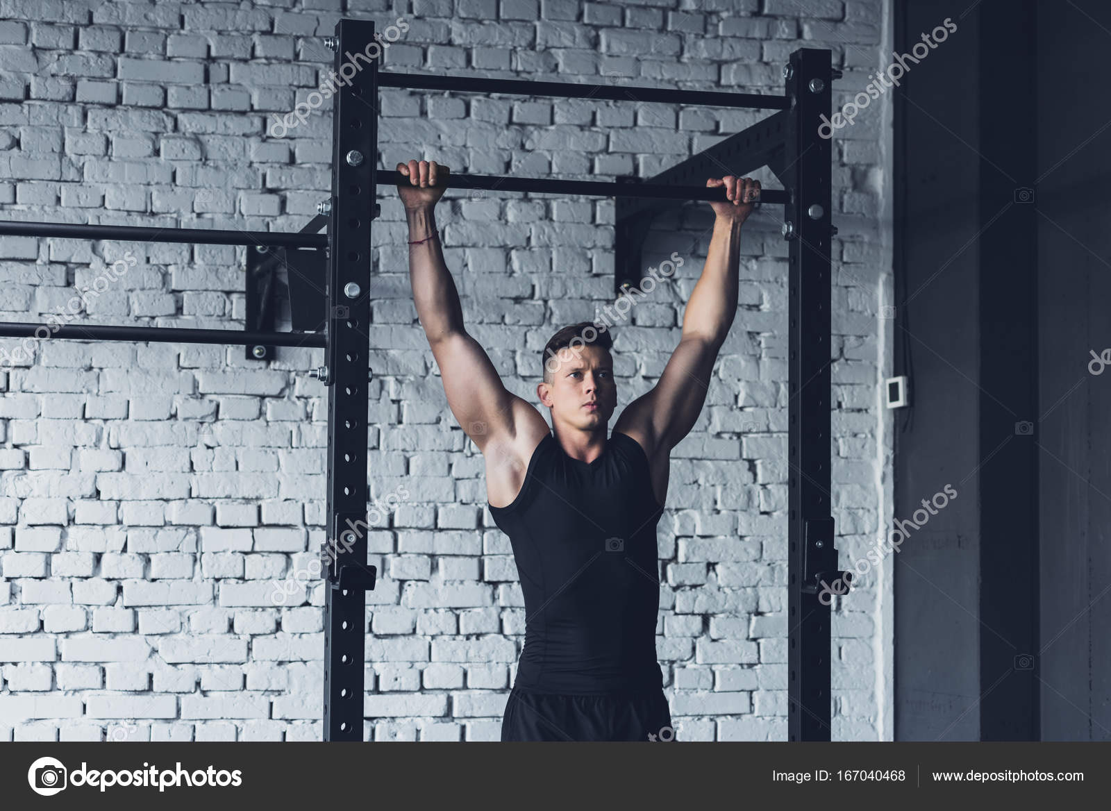 Man doing pull ups Stock Photo by ©alebloshka 167040468