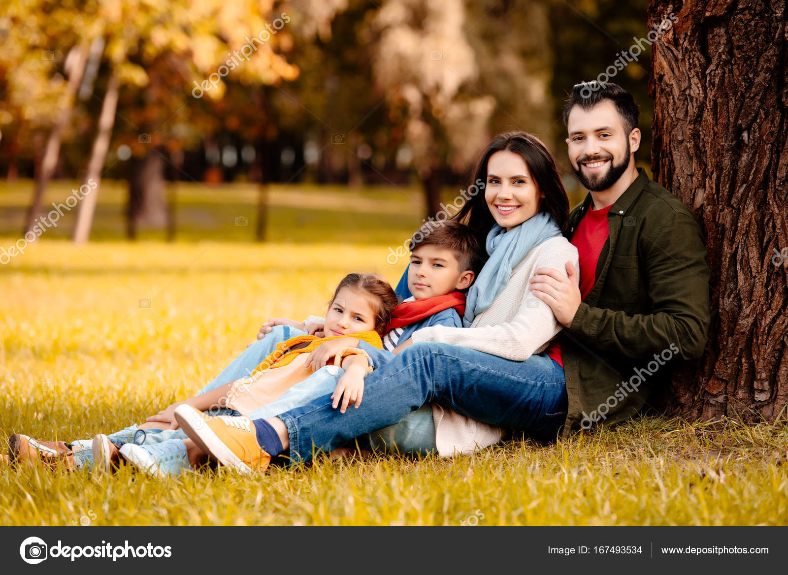 Happy family leaning on tree — Stock Photo © alebloshka #167493534