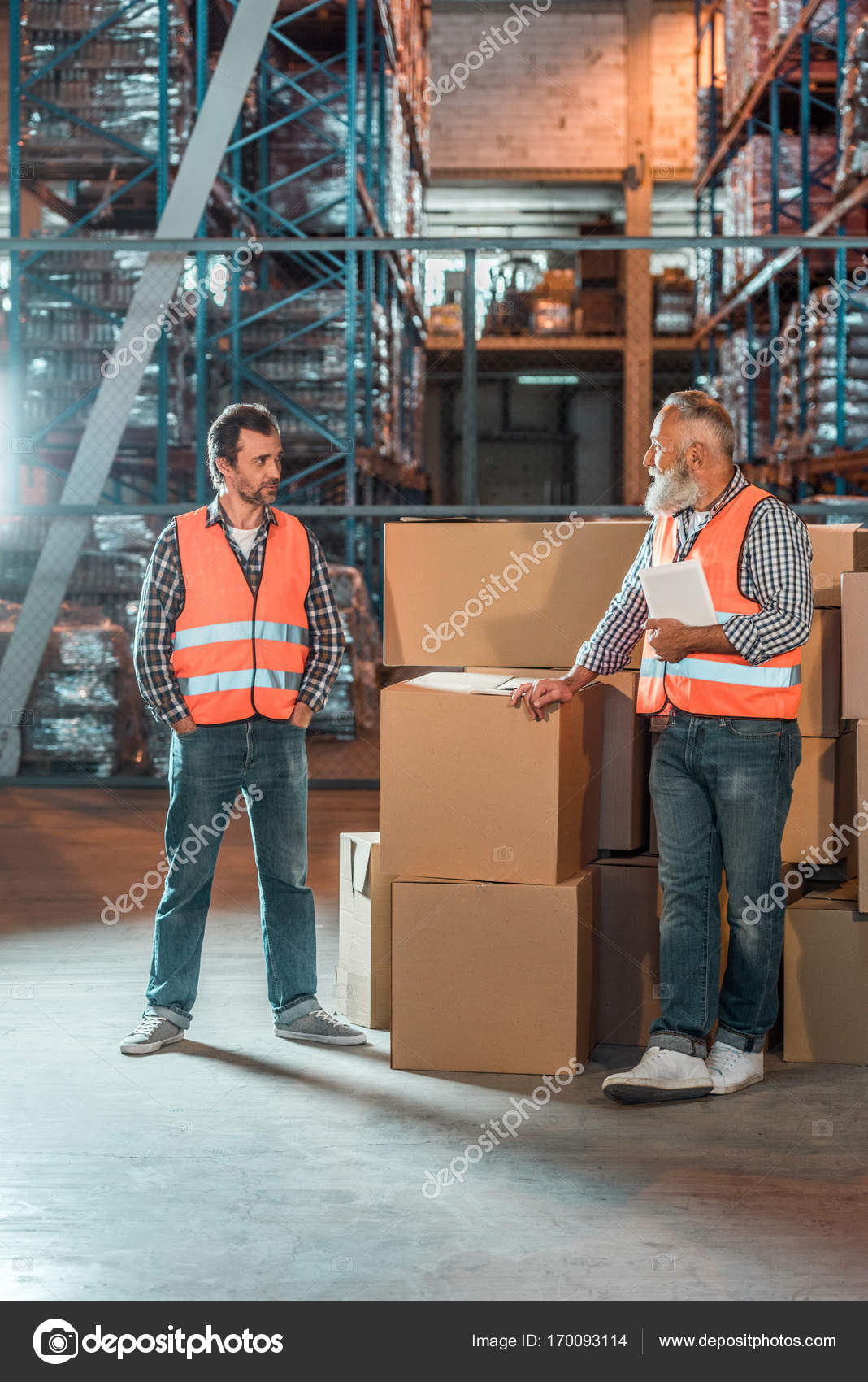 Warehouse workers with digital tablet Stock Photo by ©alebloshka 170093114
