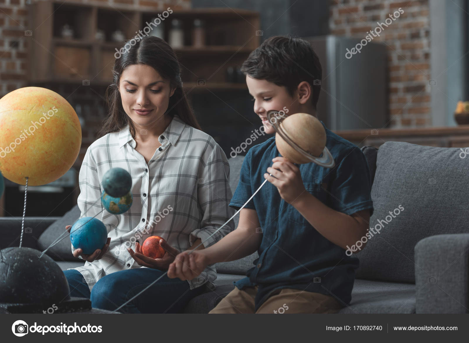 Mother and son assembling Galaxy model — Stock Photo © alebloshka ...