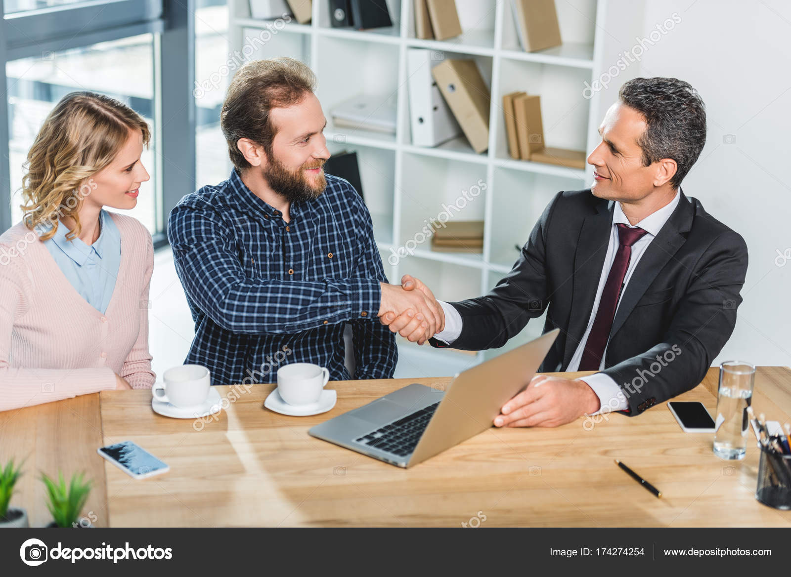 Lawyer and client shaking hands Stock Photo by ©alebloshka 174274254