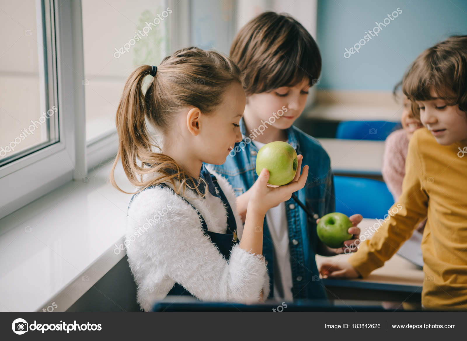 Teen Schoolchildren Eating Apples Together Classroom Stock Photo by ...
