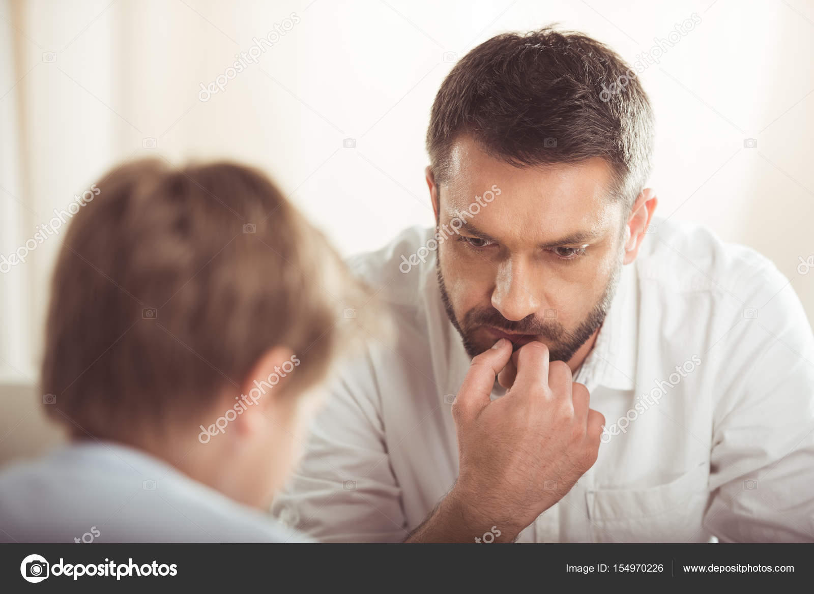 Pensive man with hand on chin — Stock Photo © GeneGlavitsky #154970226 Pensive man with hand on chin — Stock Photo © GeneGlavitsky #154970226