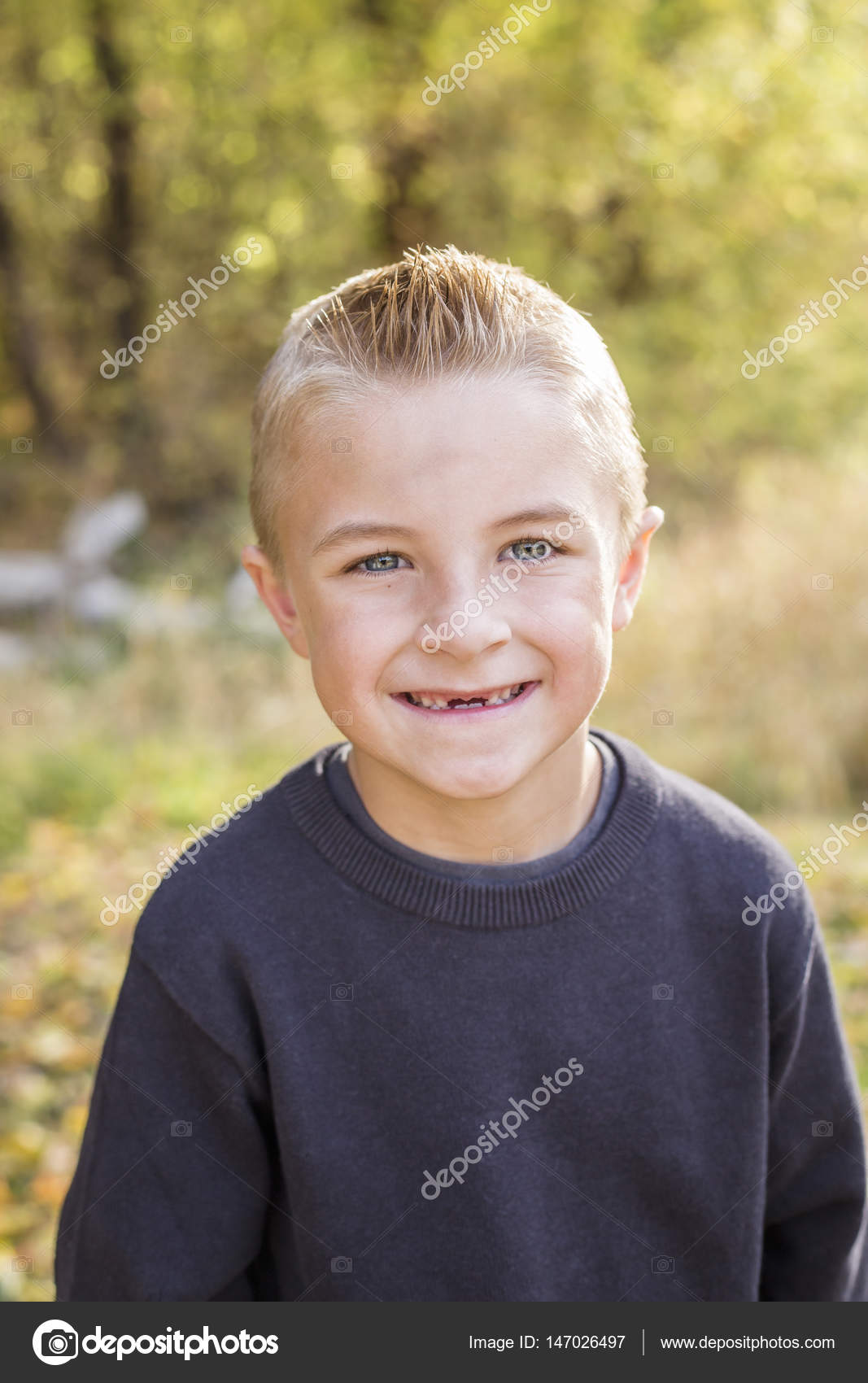 Cute, smiling, young boy portrait outdoors. He's got a big toothless ... Cute, smiling, young boy portrait outdoors. He's got a big toothless ...