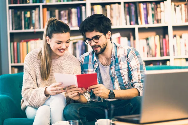 Two people reading book in cafe and enjoying time together - Stock ...