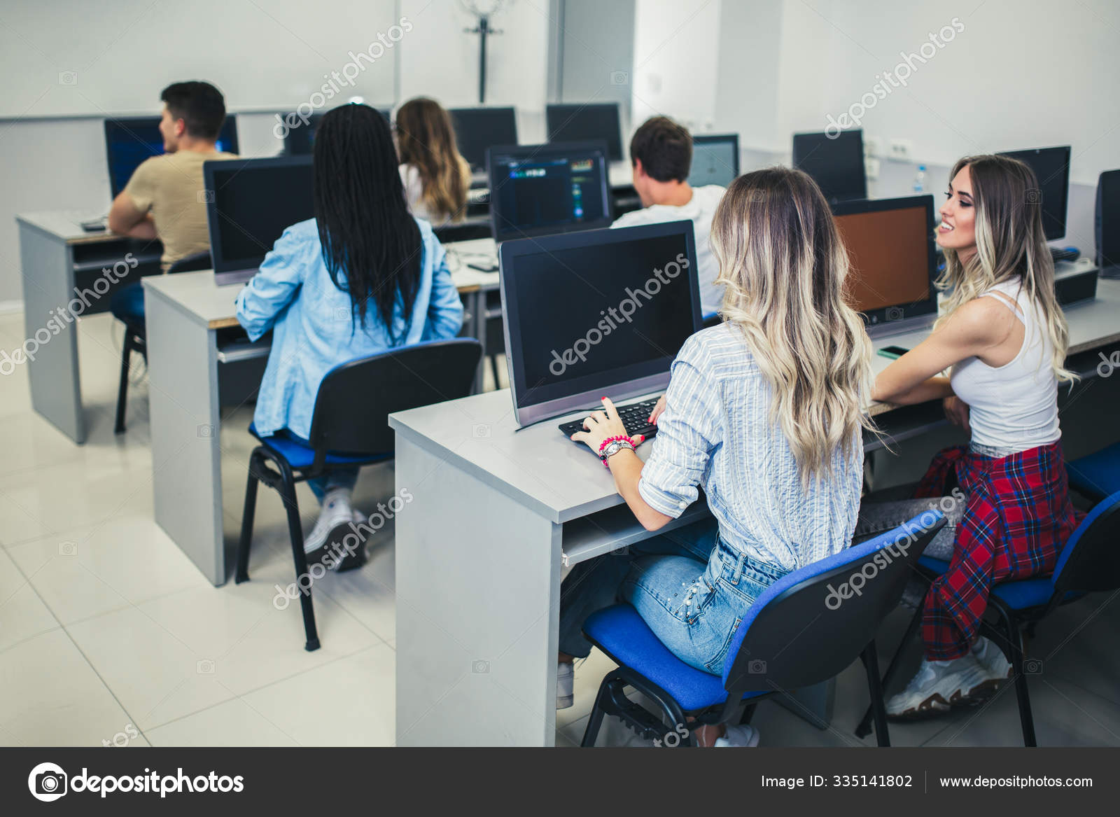 College students sitting in a classroom, using computers during Stock ...