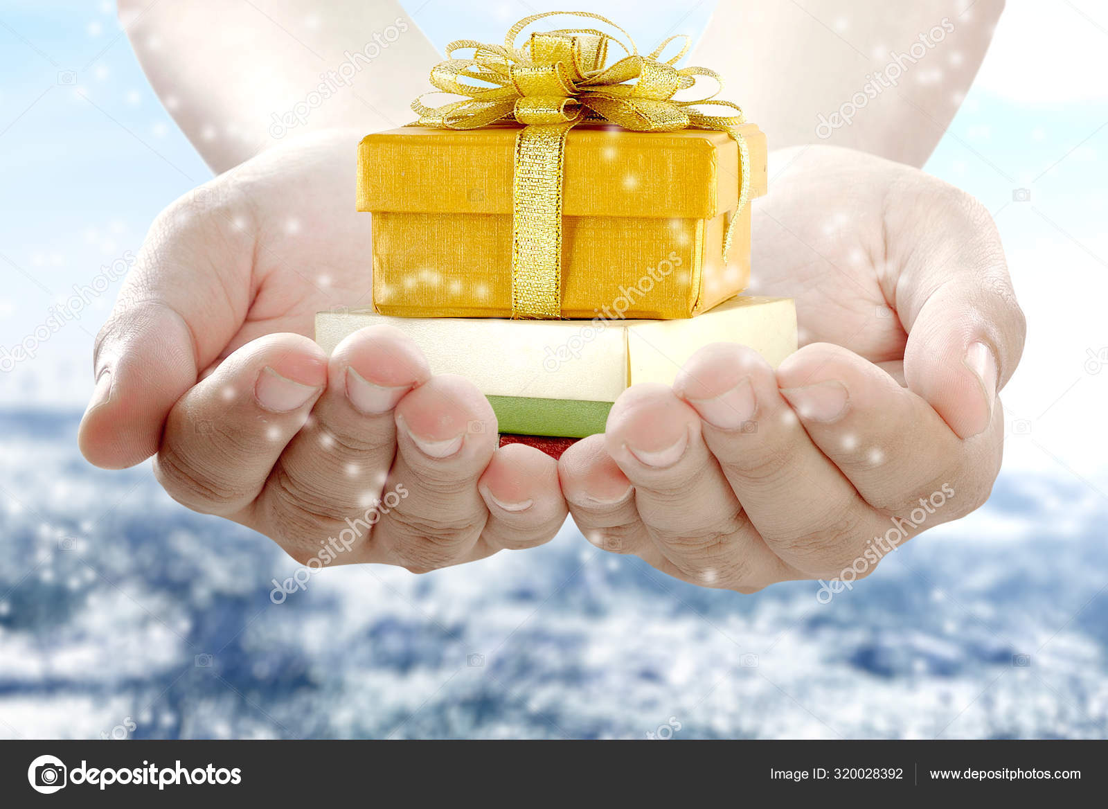Hands holding colorful gift box with ribbon Stock Photo by ©leolintang ...