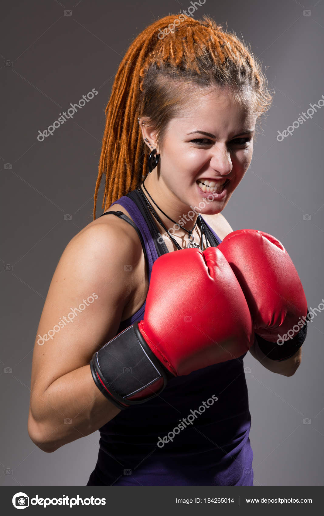 Young woman boxer with dreadlocks with clenched teeth — Stock Photo ...