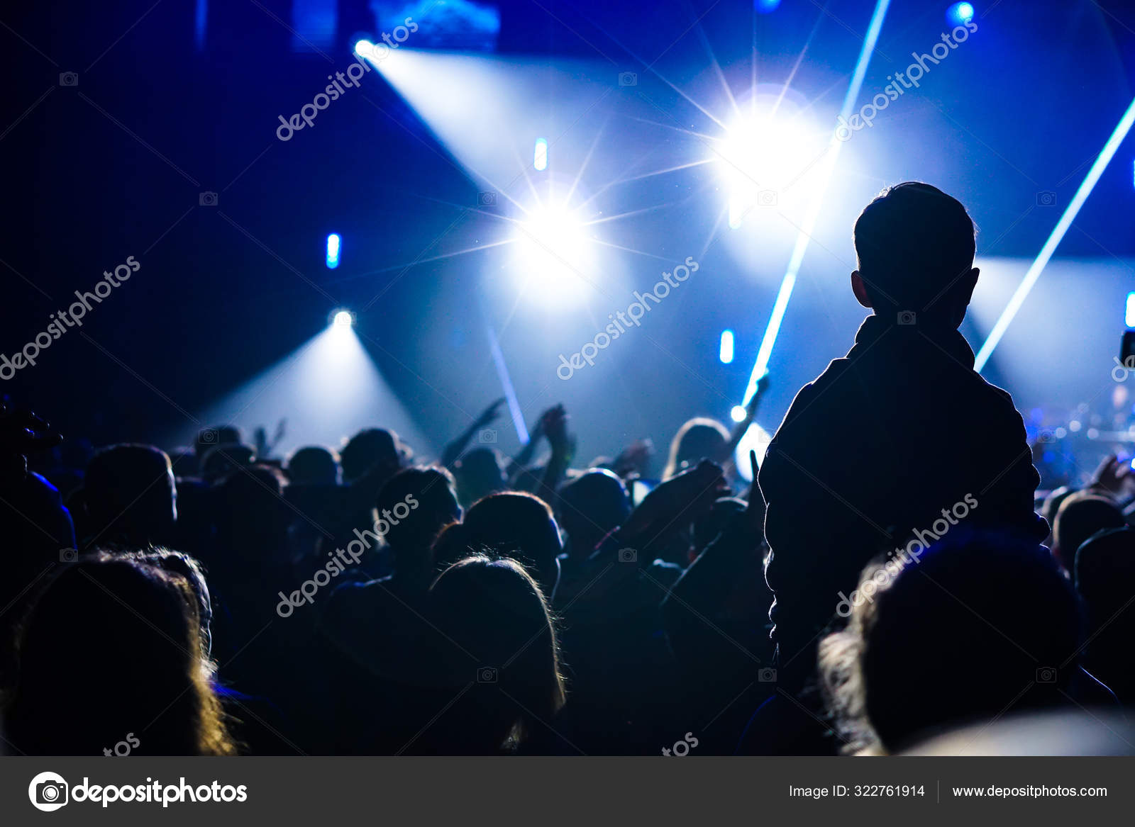 Girls with hands up dancing, singing and listening the music during ...