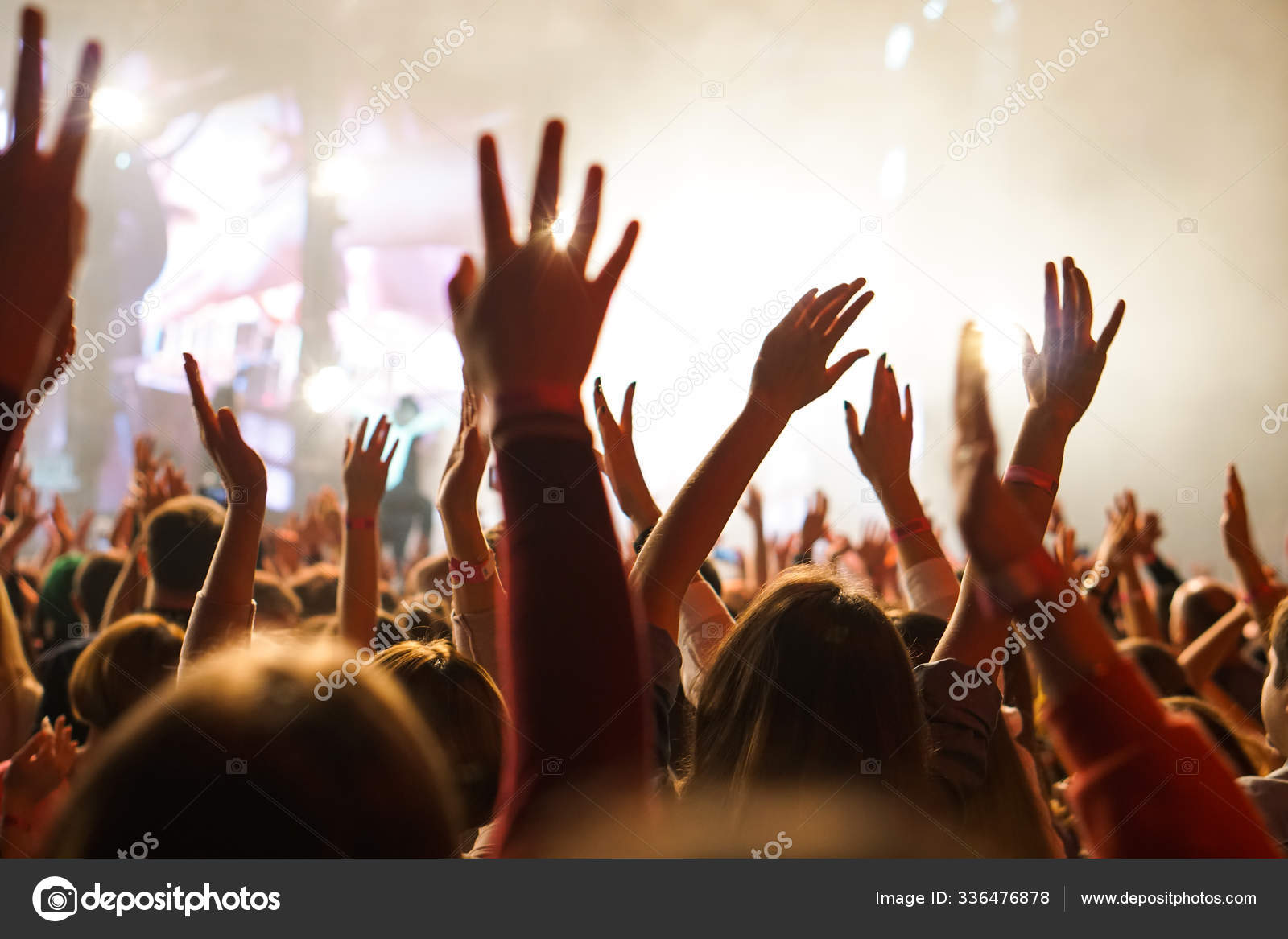 Crowd Of People With Hands Up