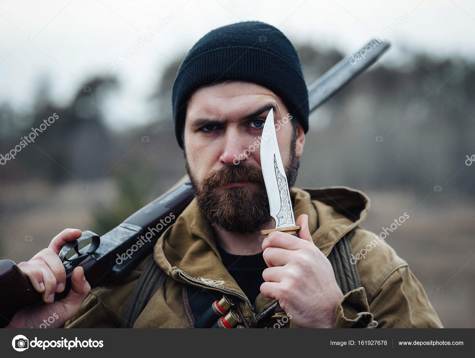 Bearded hunter with professional equipment walking in the woods Stock ...