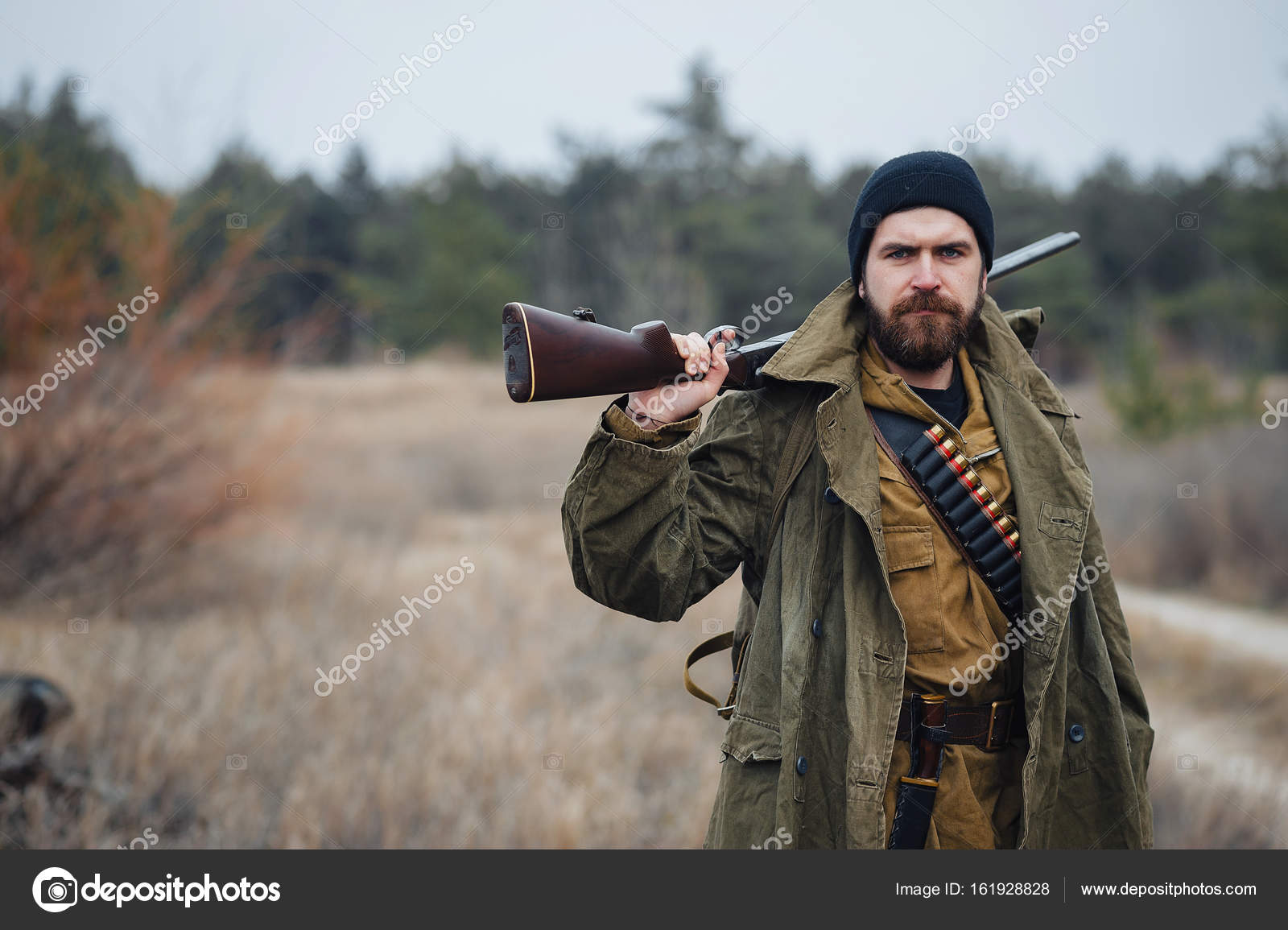 Bearded hunter with professional equipment walking in the woods Stock ...