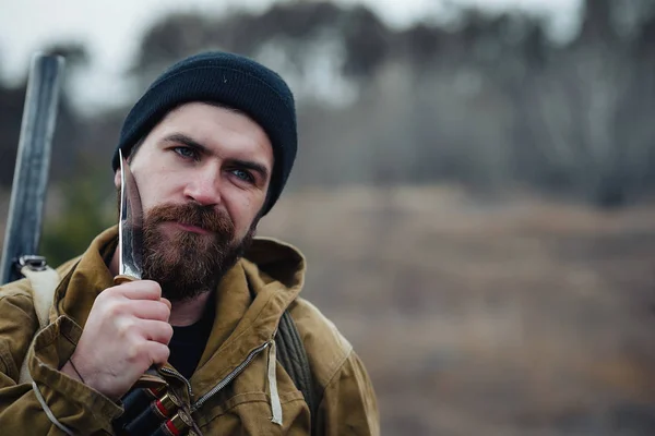 Bearded hunter with professional equipment walking in the woods Stock ...
