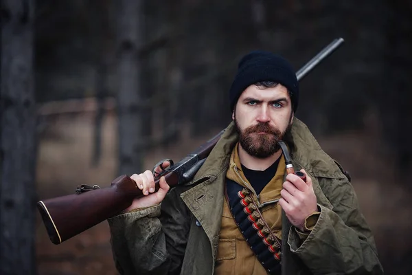 Bearded hunter with professional equipment walking in the woods Stock ...