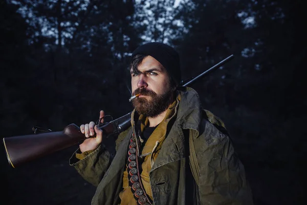 Bearded hunter with professional equipment walking in the woods Stock ...