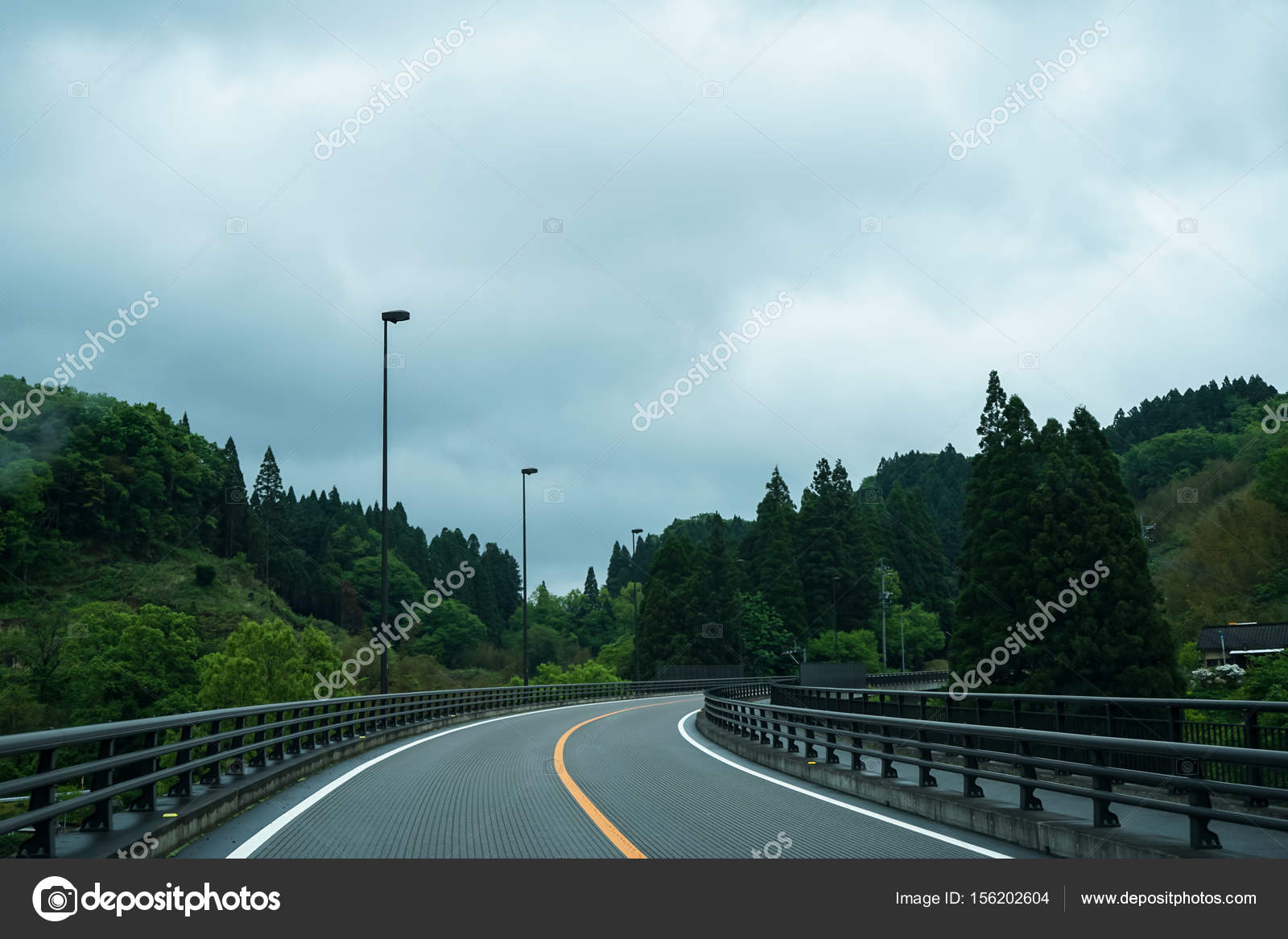 On curved road trip after raining through local green scenic hig ...