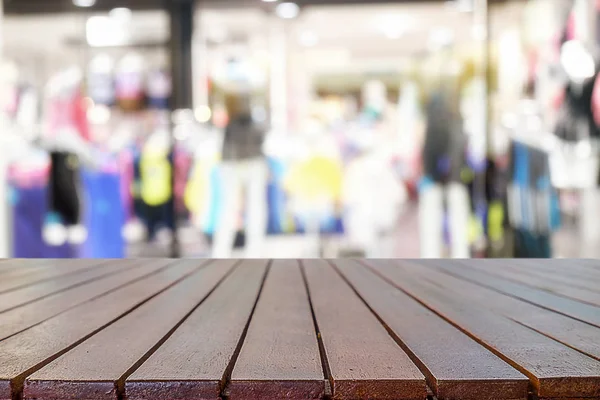 Empty wooden table space platform and blurred shopping mall or shopping ...
