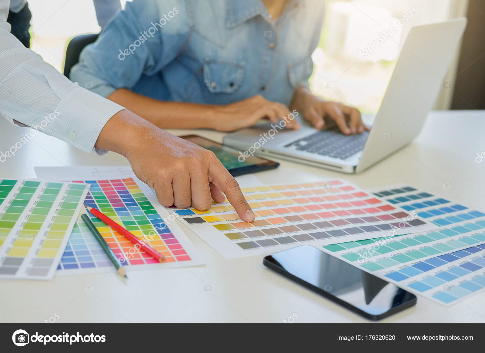 Graphic design and color swatches and pens on a desk. Architectu ...