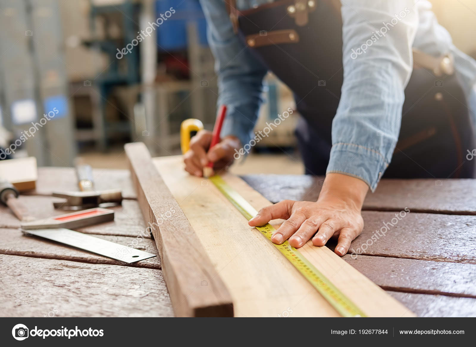 Carpenter working on woodworking machines in carpentry shop. wom Stock ...