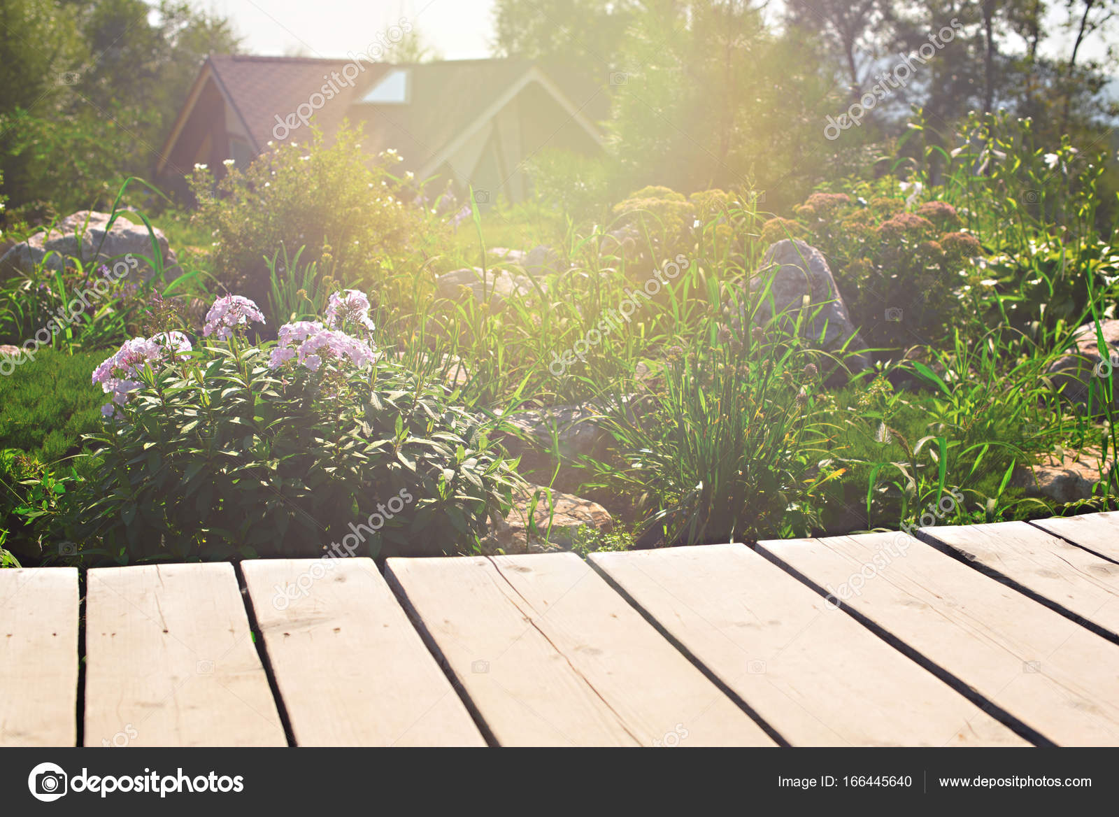 Wooden table on a background of garden flowers. ⬇ Stock Photo, Image by ...