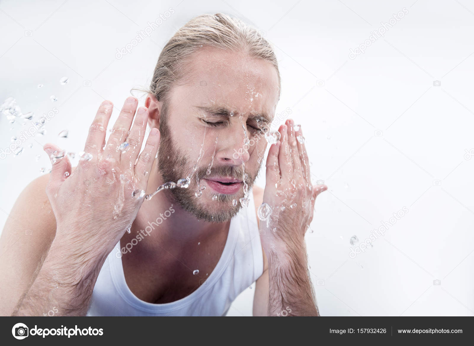 Young man washing face — Stock Photo © IgorVetushko #157932426