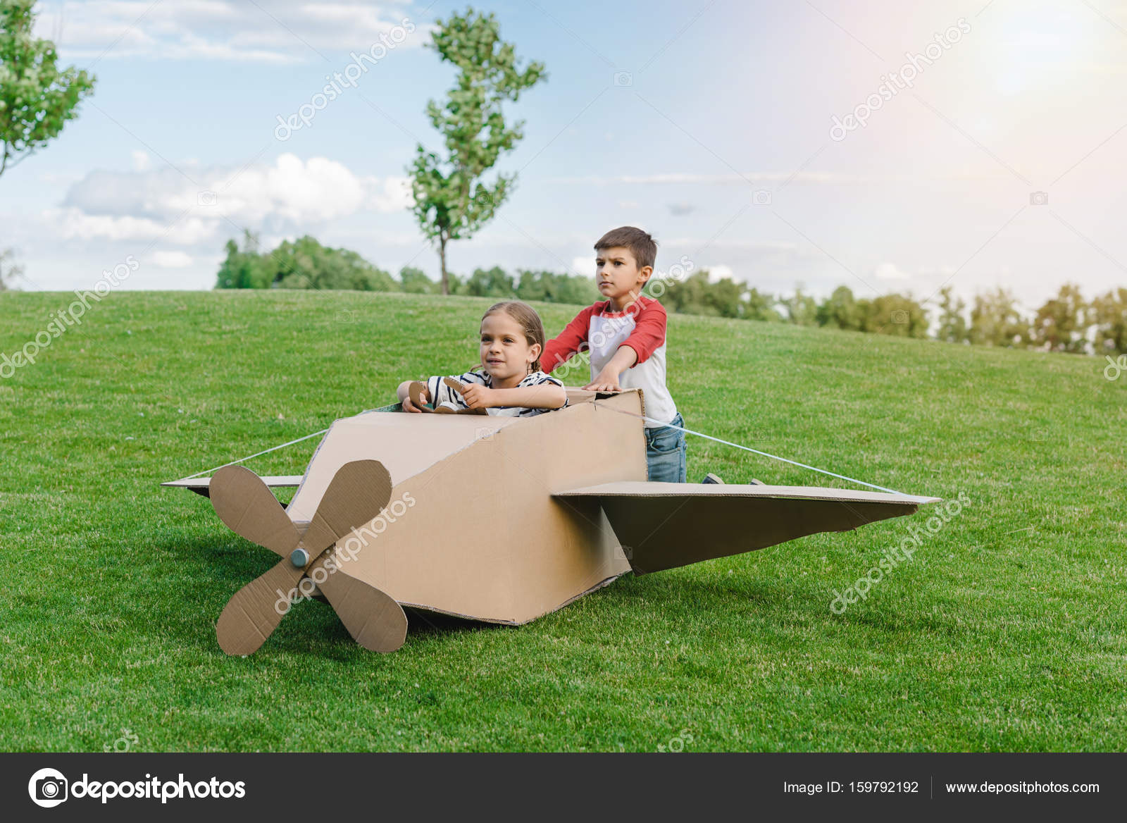 Children playing with plane in park — Stock Photo © IgorVetushko #159792192
