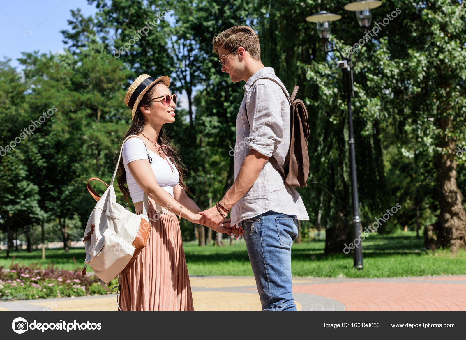Multicultural couple holding hands Stock Photo by ©IgorVetushko 160198050 Multicultural couple holding hands Stock Photo by ©IgorVetushko 160198050