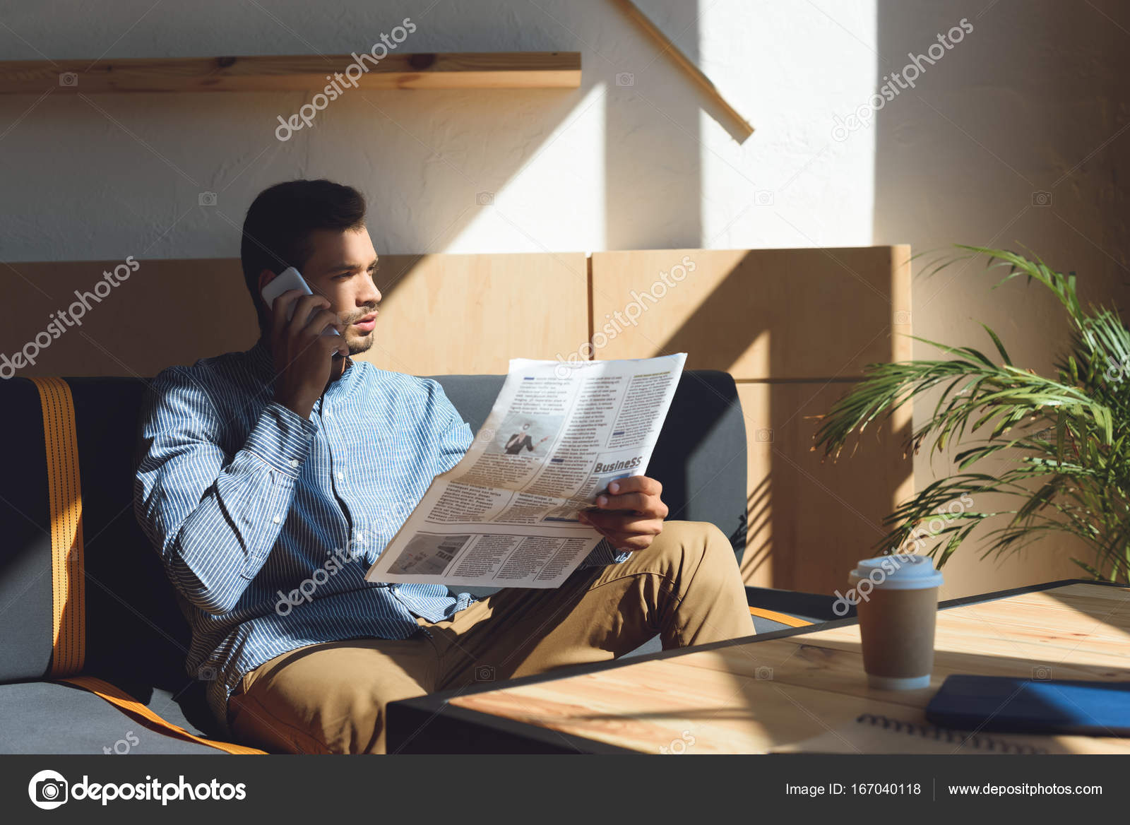 Man with smartphone reading newspaper — Free Stock Photo © IgorVetushko ...