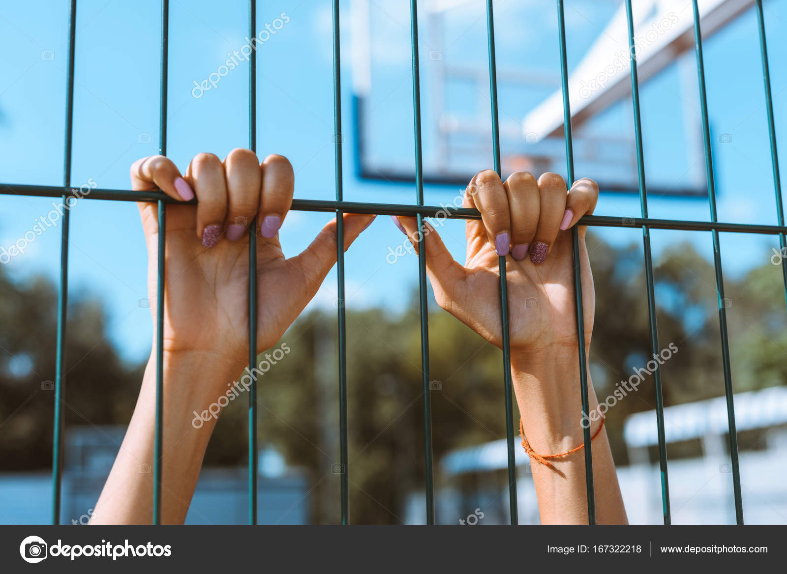 Hands clinging onto fencing — Stock Photo © IgorVetushko #167322218