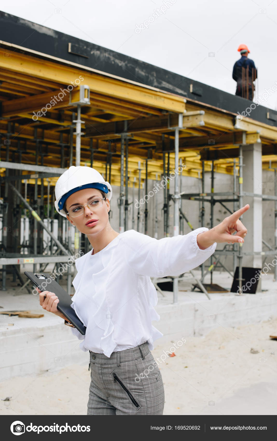 Engineer pointing at construction site — Stock Photo © IgorVetushko ...