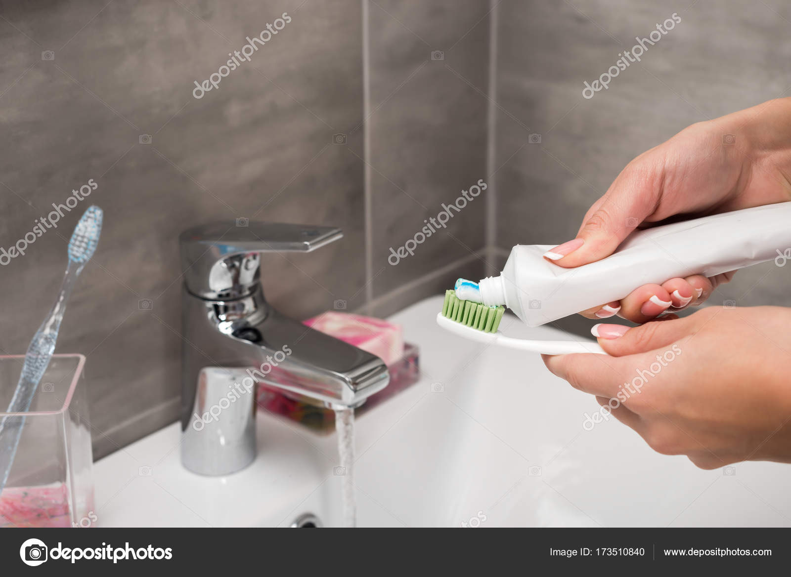 Girl applying toothpaste on toothbrush — Stock Photo © IgorVetushko ...
