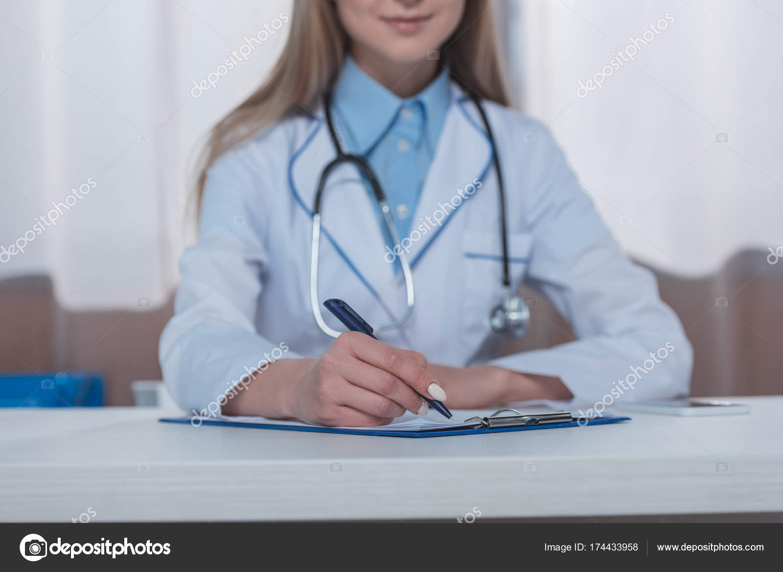 Doctor writing something on clipboard — Stock Photo © IgorVetushko ...