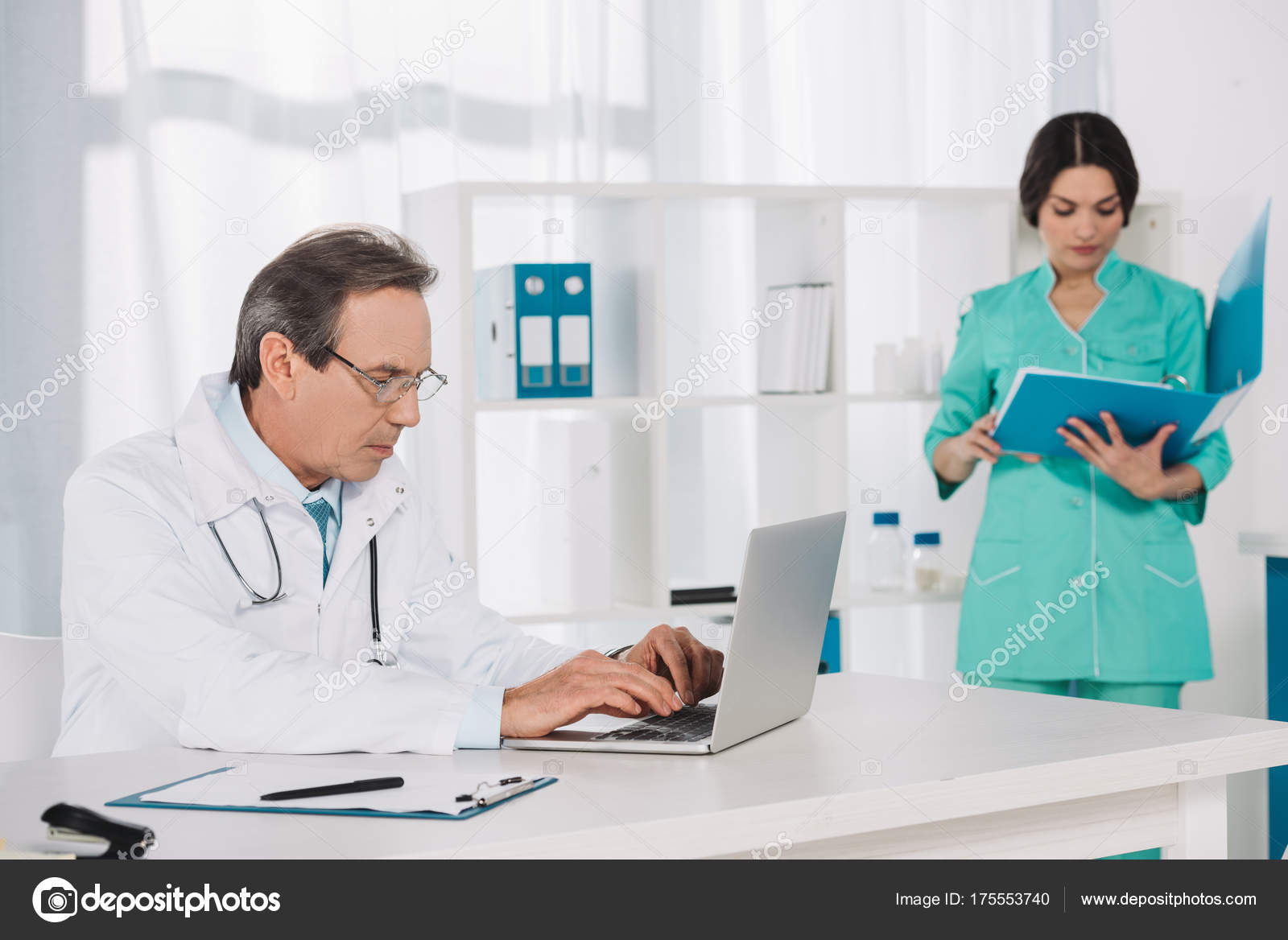 Nurse Searching Something Folder Doctor Using Laptop Stock Photo by ...