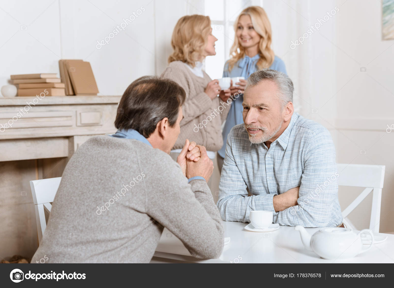 Men Speaking Table While Women Standing Background Stock Photo by ...