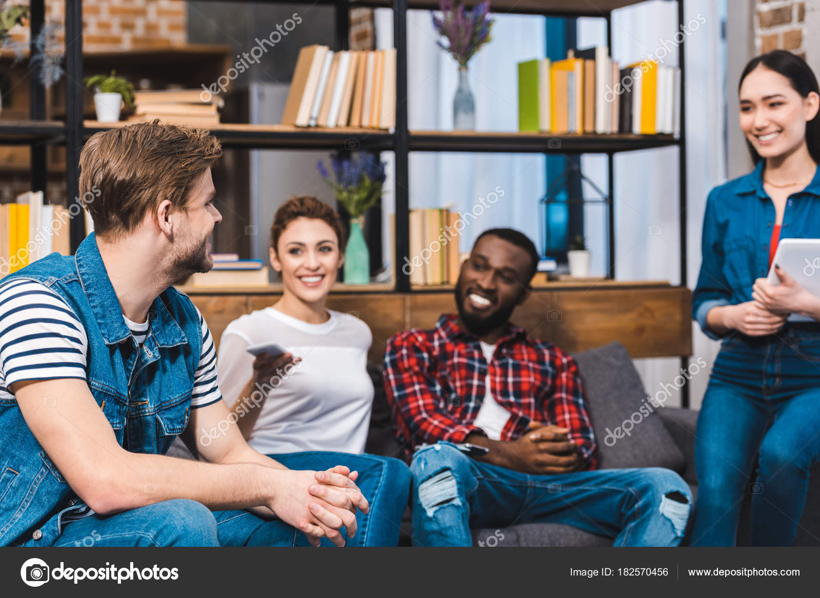 Cheerful Young Multiethnic Friends Using Digital Tablet Smartphone Home ... Cheerful Young Multiethnic Friends Using Digital Tablet Smartphone Home ...
