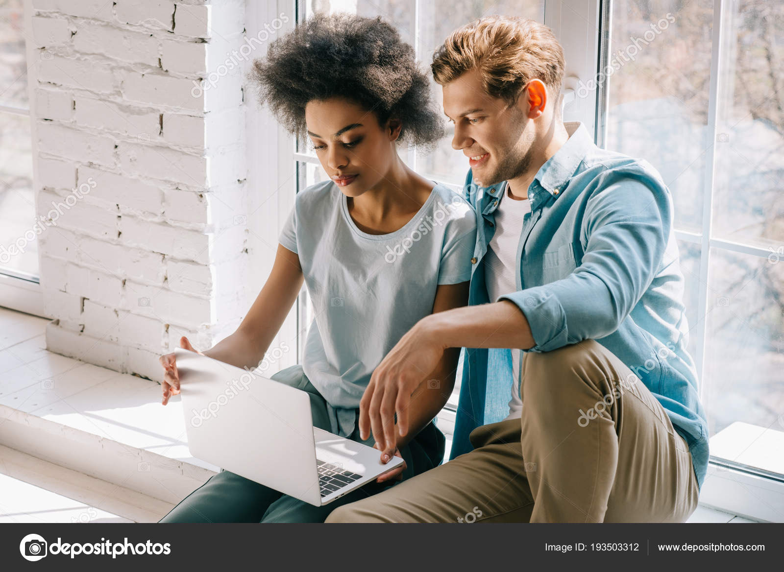 Multiracial Couple Looking Laptop Screen While Sitting Window — Stock ...