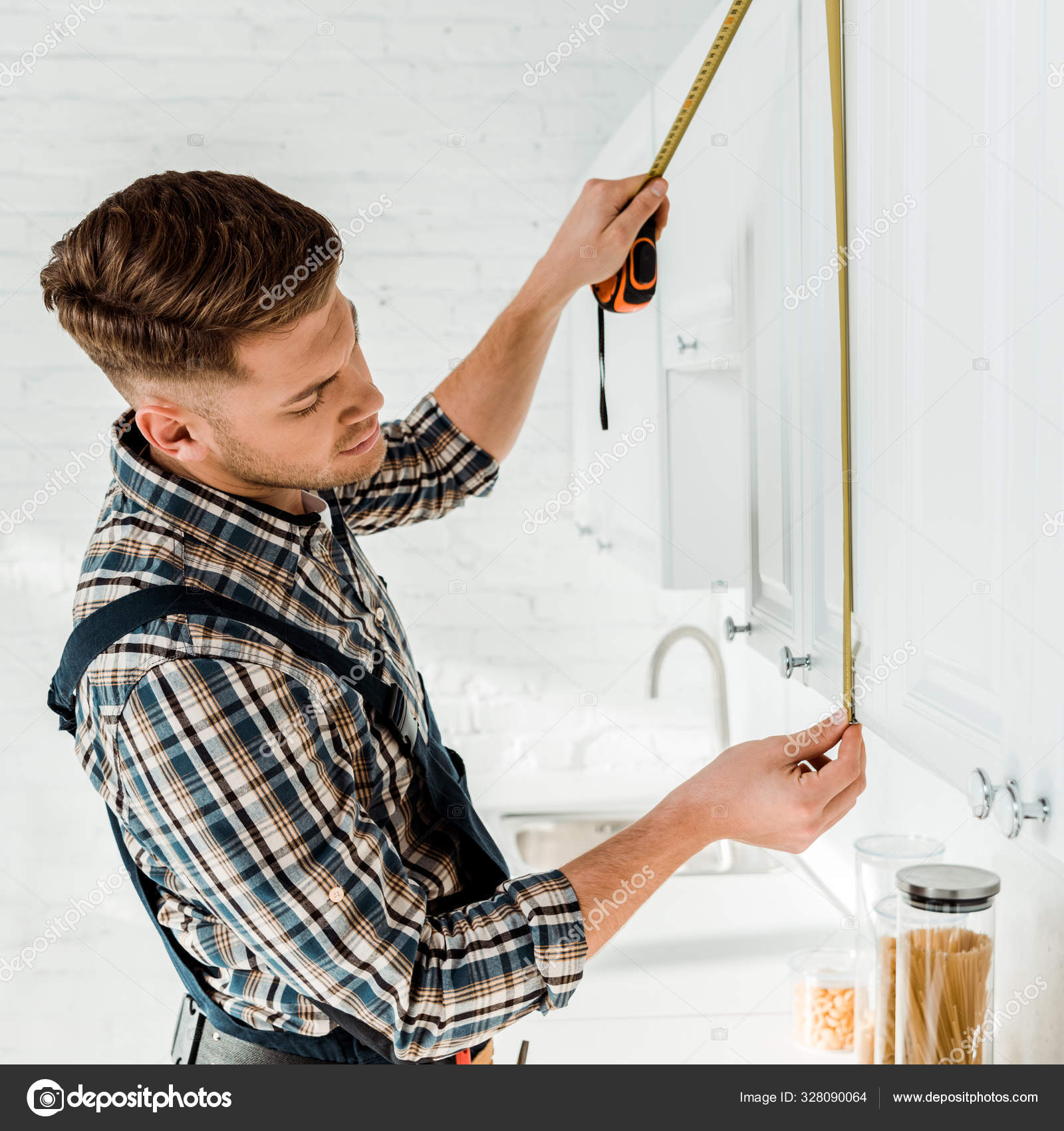 Handsome Installer Measuring White Kitchen Cabinet Stock Photo by ...