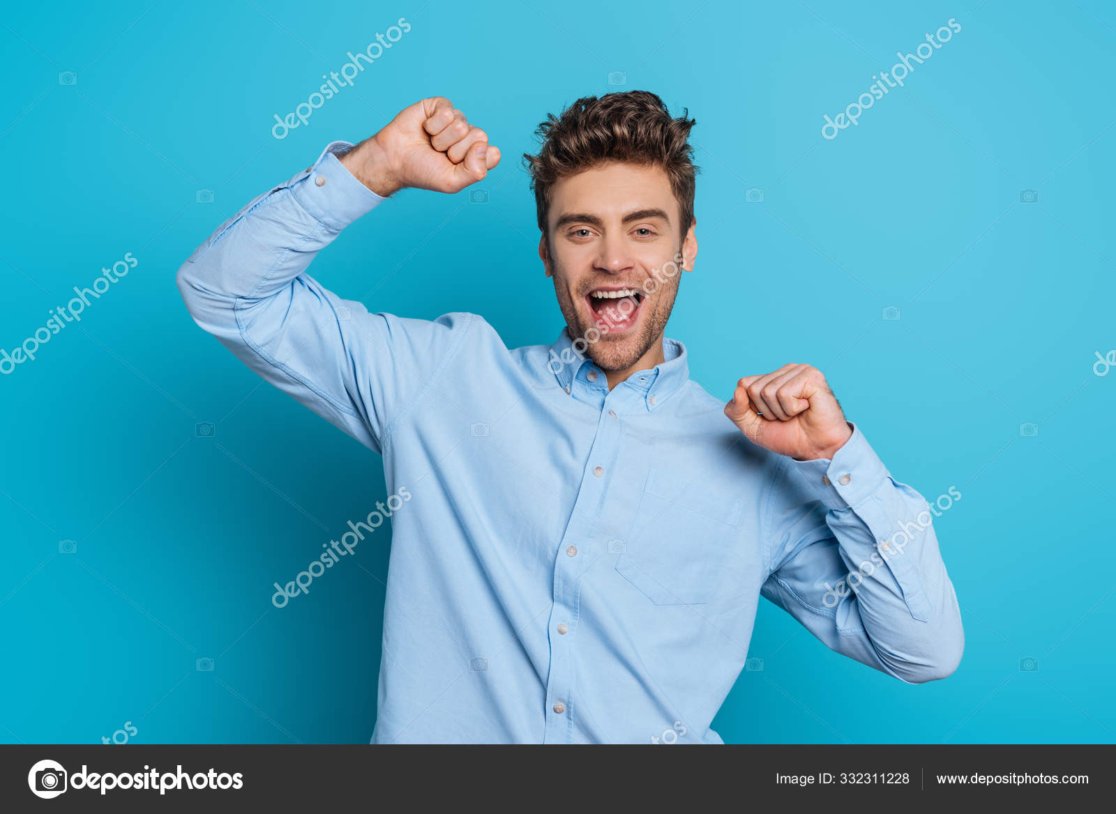 Excited Young Man Showing Winner Gesture While Smiling Camera Blue ...