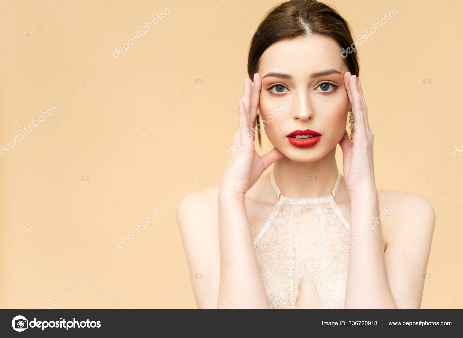 Attractive Young Woman Looking Camera While Touching Temples Isolated