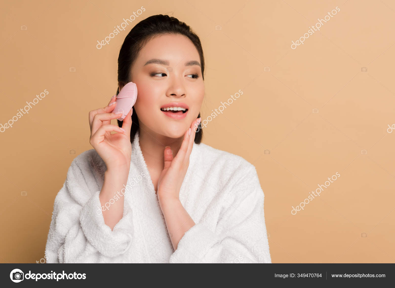 Beautiful Asian Woman Bathrobe Using Facial Cleansing Brush Beige