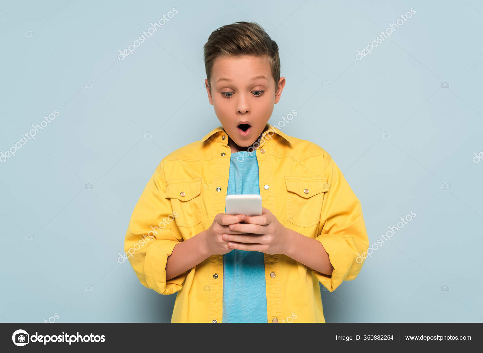 Shocked Kid Using Looking Smartphone Blue Background Stock Photo by ...
