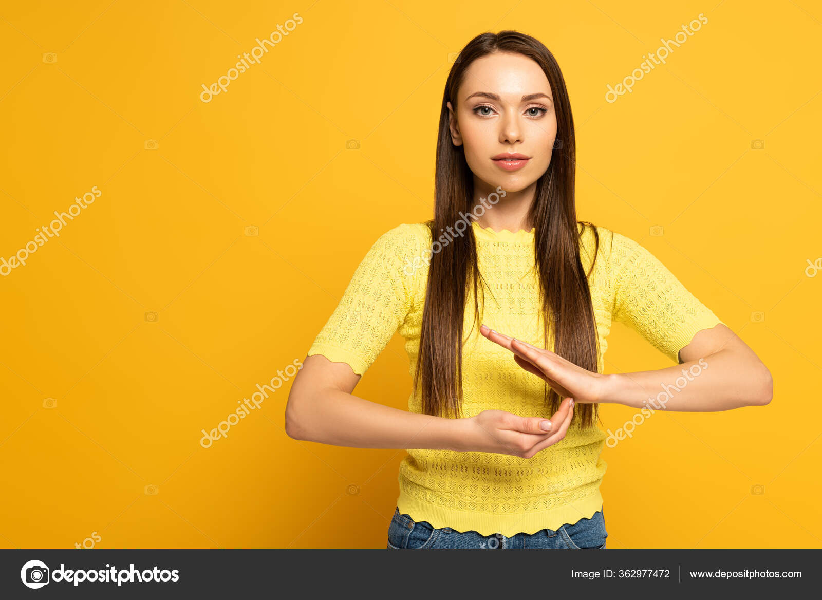 Young Woman Gesturing While Using Sign Language Yellow Background Stock ...
